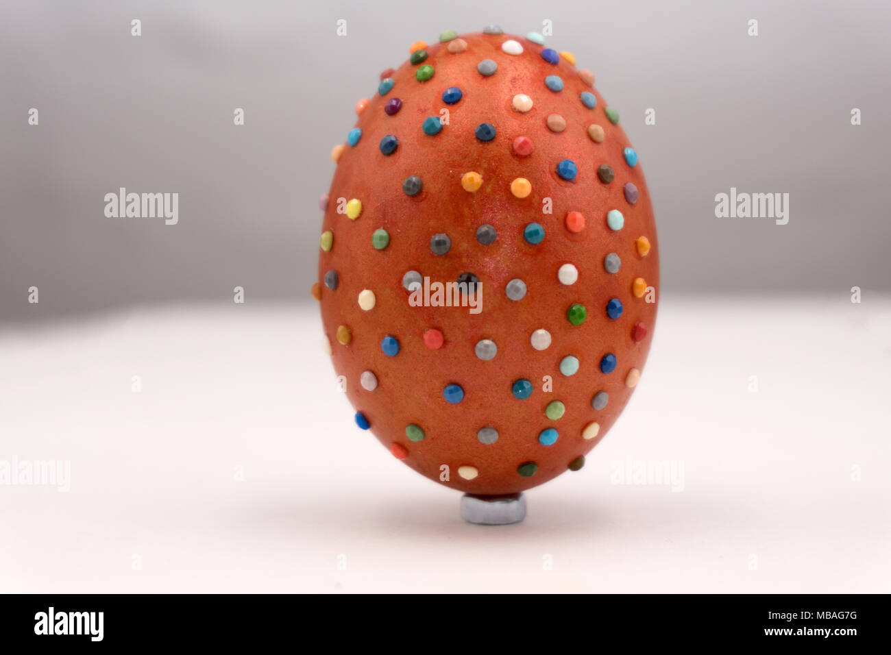 Elegant gold and silver bejeweled egg-shaped ornament with gold mesh ...