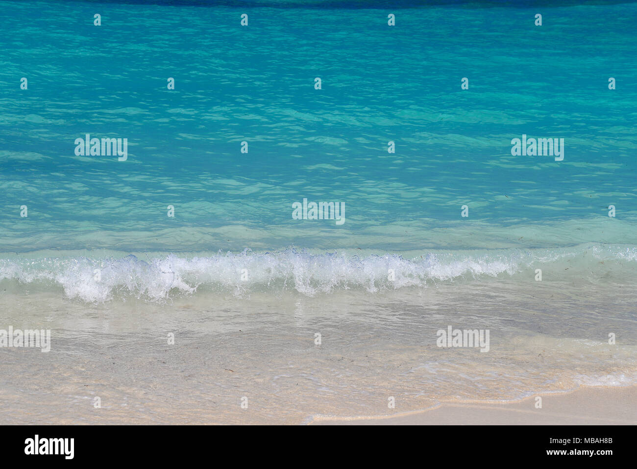 sunlit wave on turquoise ocean water in Nassau Bahamas Stock Photo - Alamy