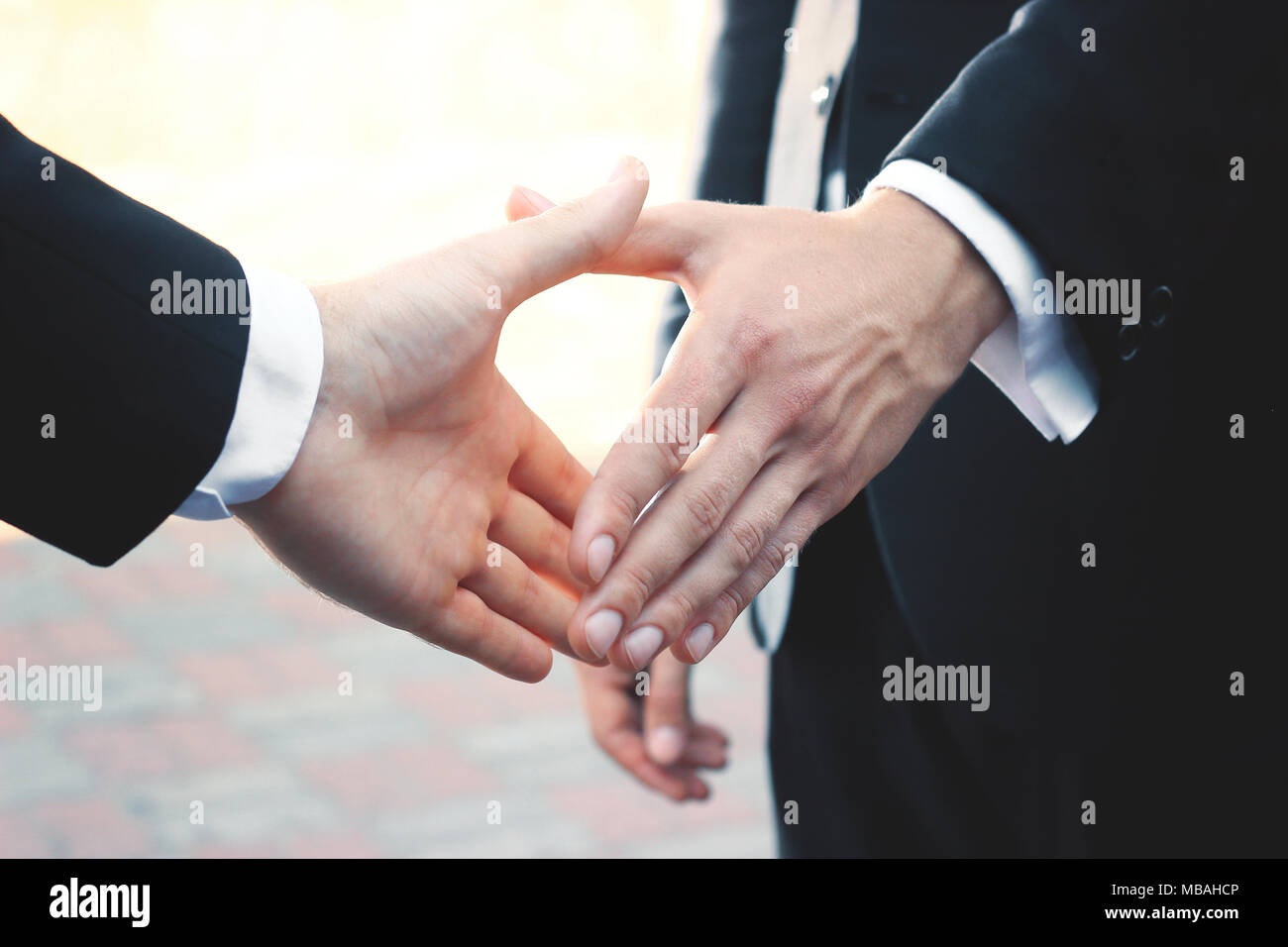 close up.two businessman holding out hand for handshake Stock Photo - Alamy