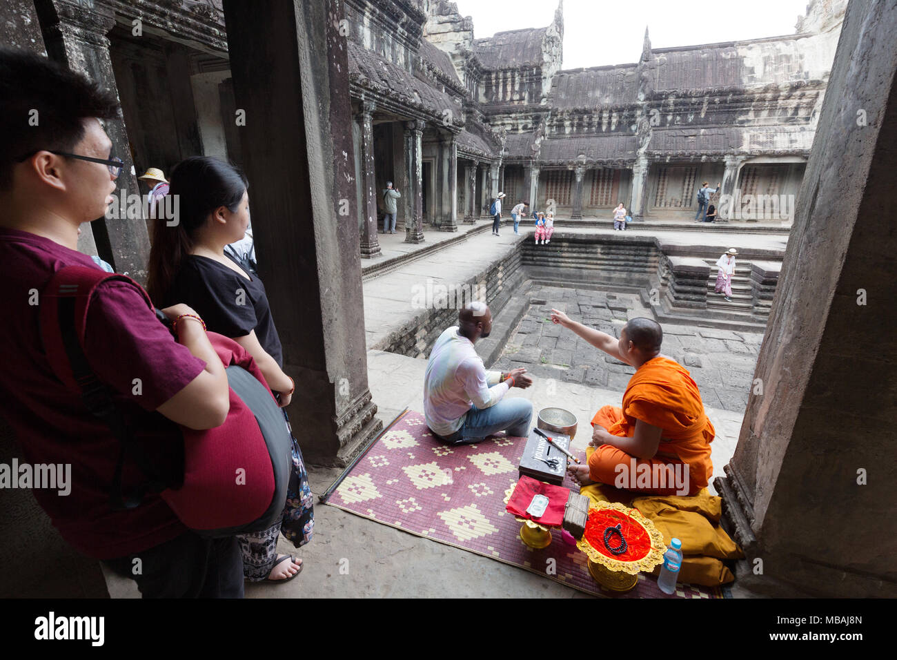 Angkor Wat monk - a monk talking with people and giving blessings ...