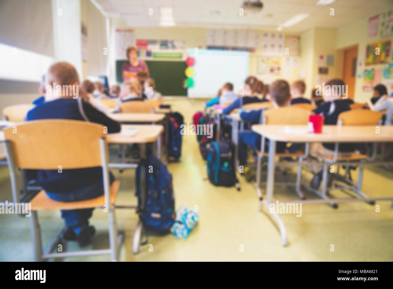 Children and teacher in class at school. Blurred view Stock Photo - Alamy