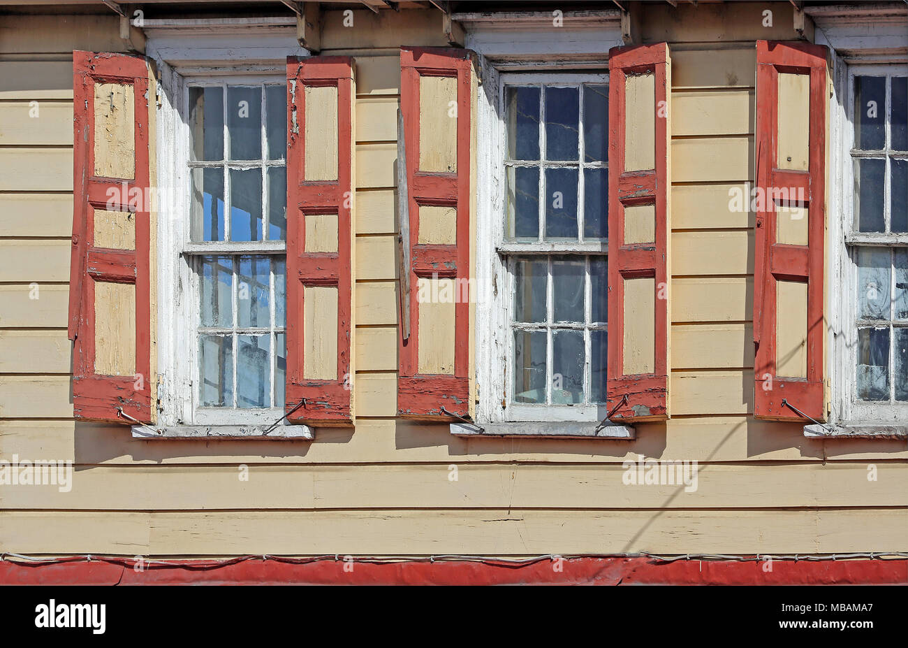 rustic building detail with tan wooden siding and windows with tan and ...