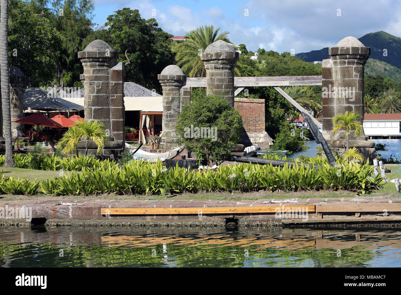 waterfront of historic Nelsons Dockyard with stone column ruins Stock ...