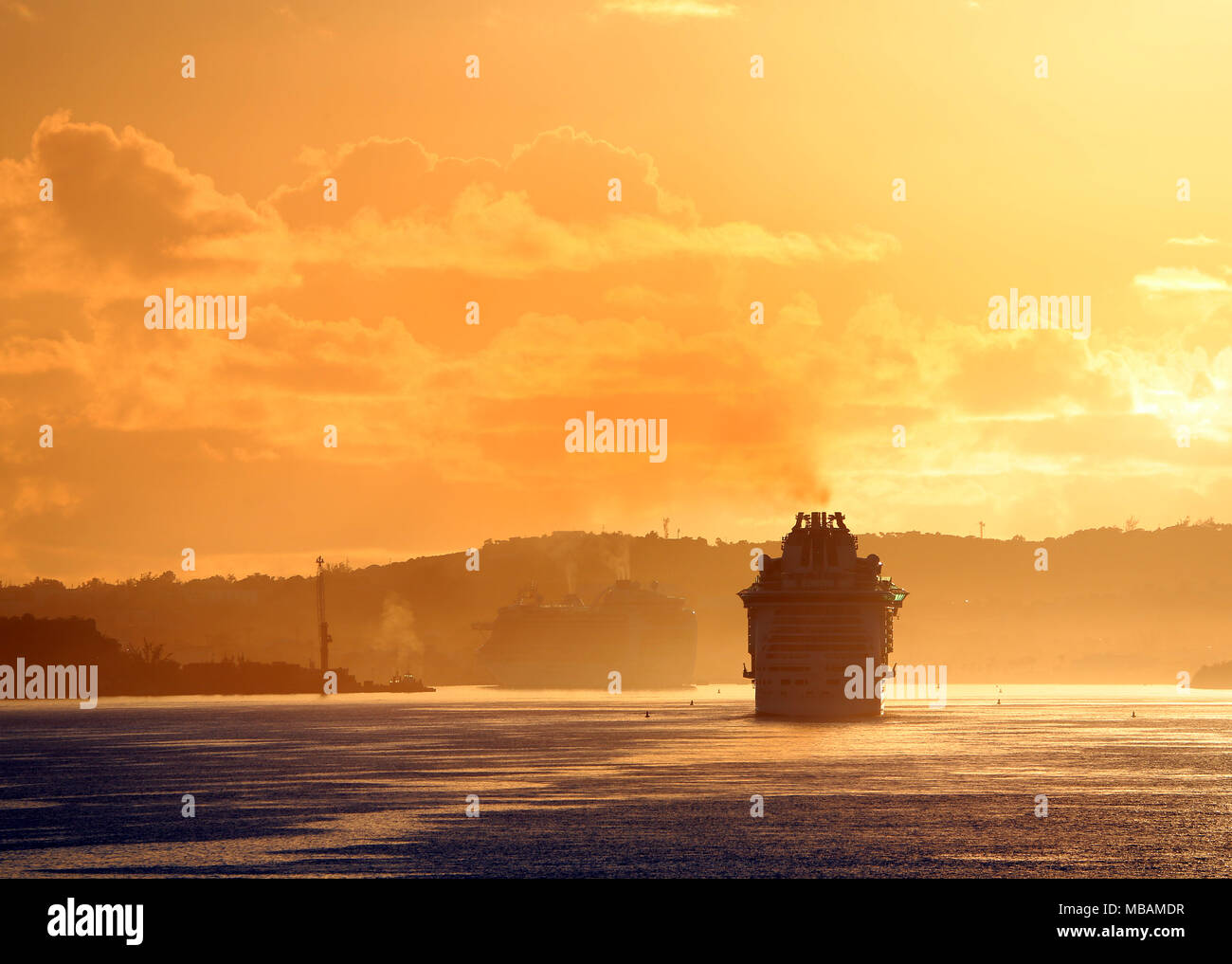 cruise ship entering into port with smoke plume ascending into golden ...