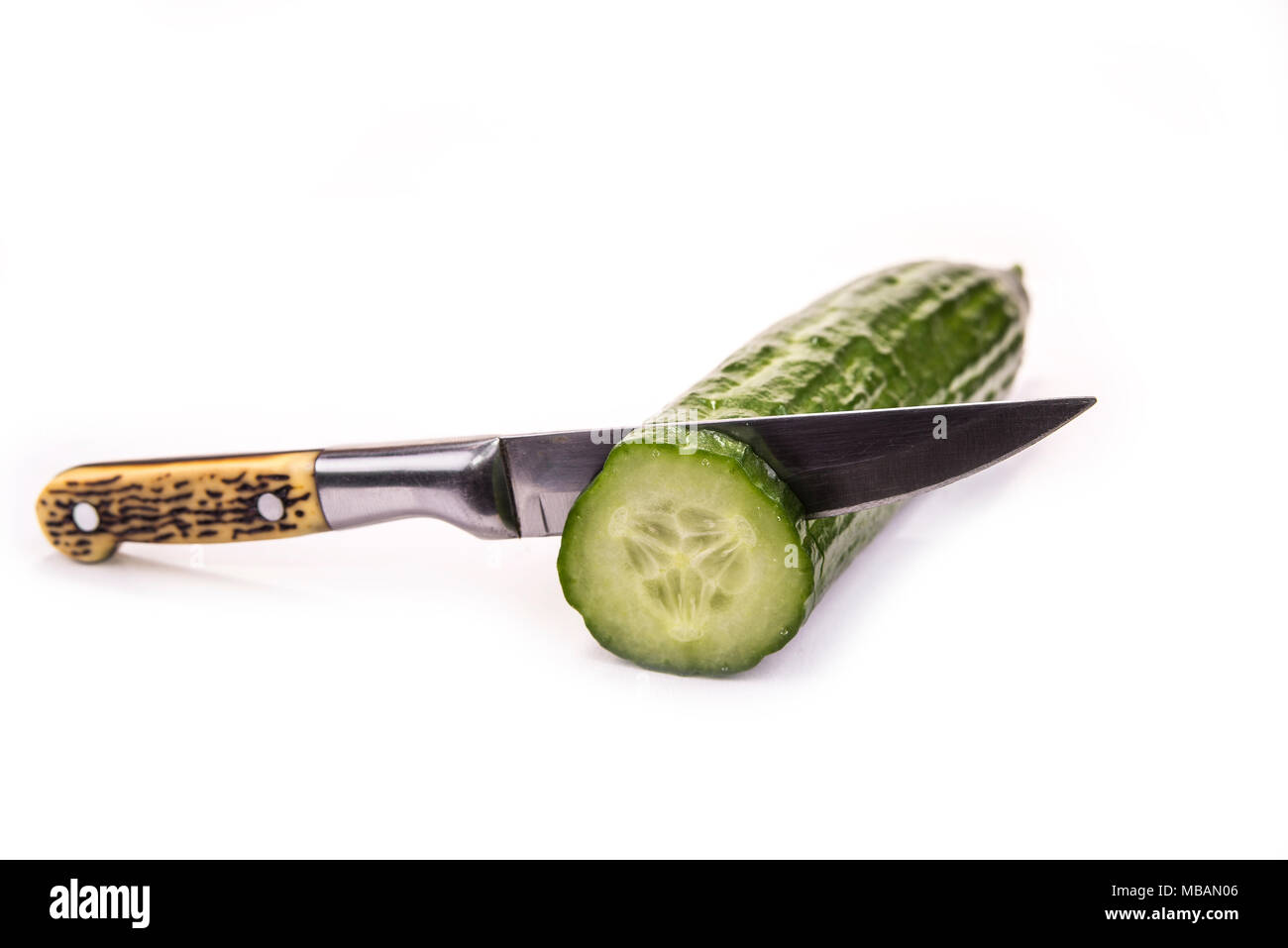Cut cucumber with knife on the white Stock Photo - Alamy