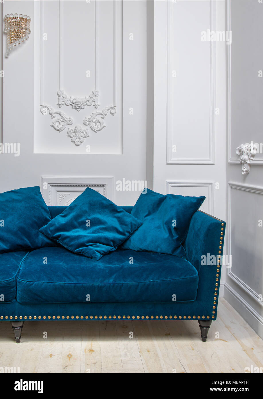 Blue couch in white interior Stock Photo - Alamy