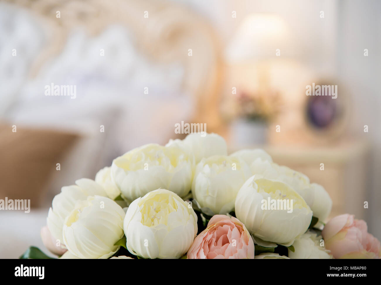 Beautiful flowers in white classic bedroom, shallow depth of field ...