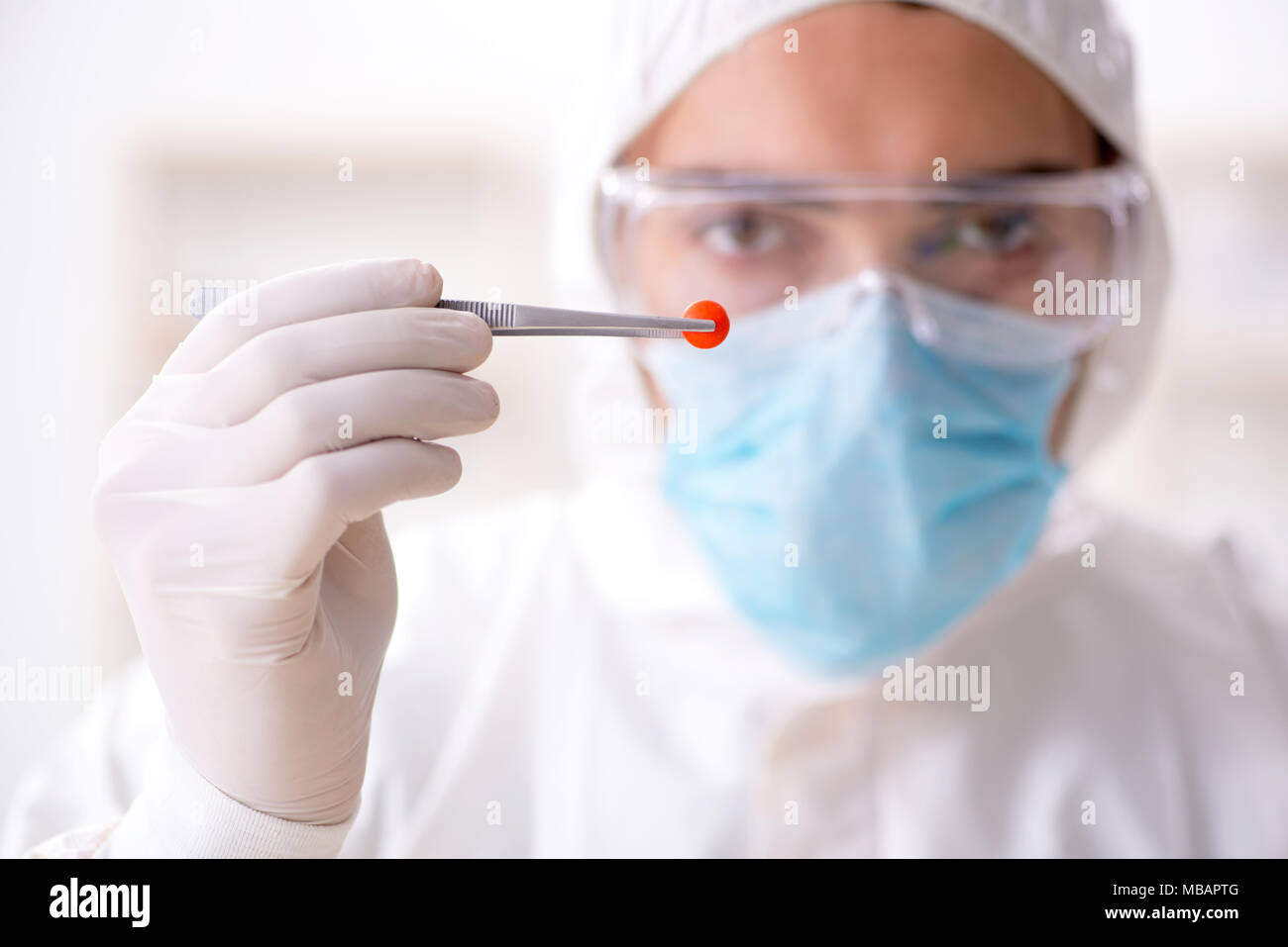 Lab assistant in drug synthesis concept Stock Photo - Alamy