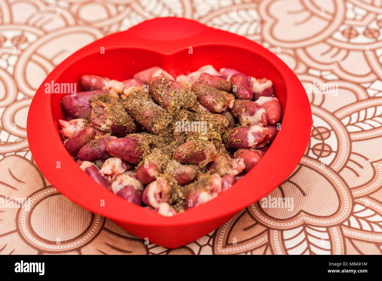 Fresh raw chicken hearts with pepper in bowl Stock Photo - Alamy