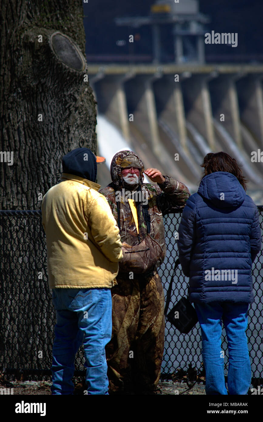 Three people standing and talking outside in Winter Stock Photo - Alamy