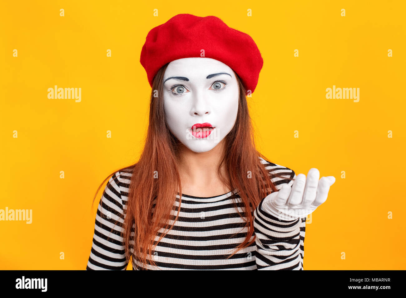 Closeup portrait of puzzlement mime woman in striped jacket. Emotions ...