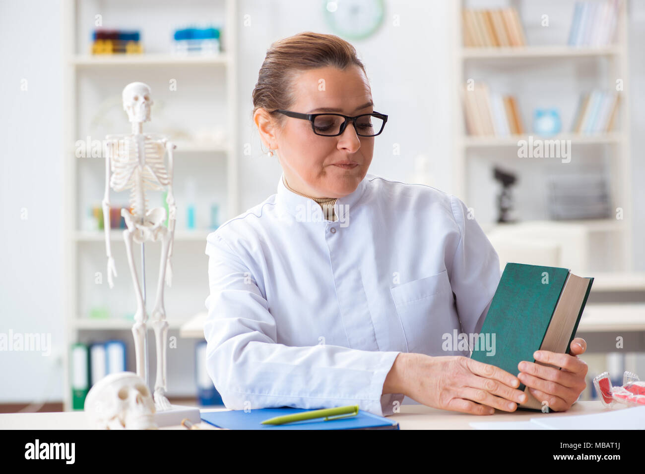 Woman doctor studying human skeleton Stock Photo - Alamy