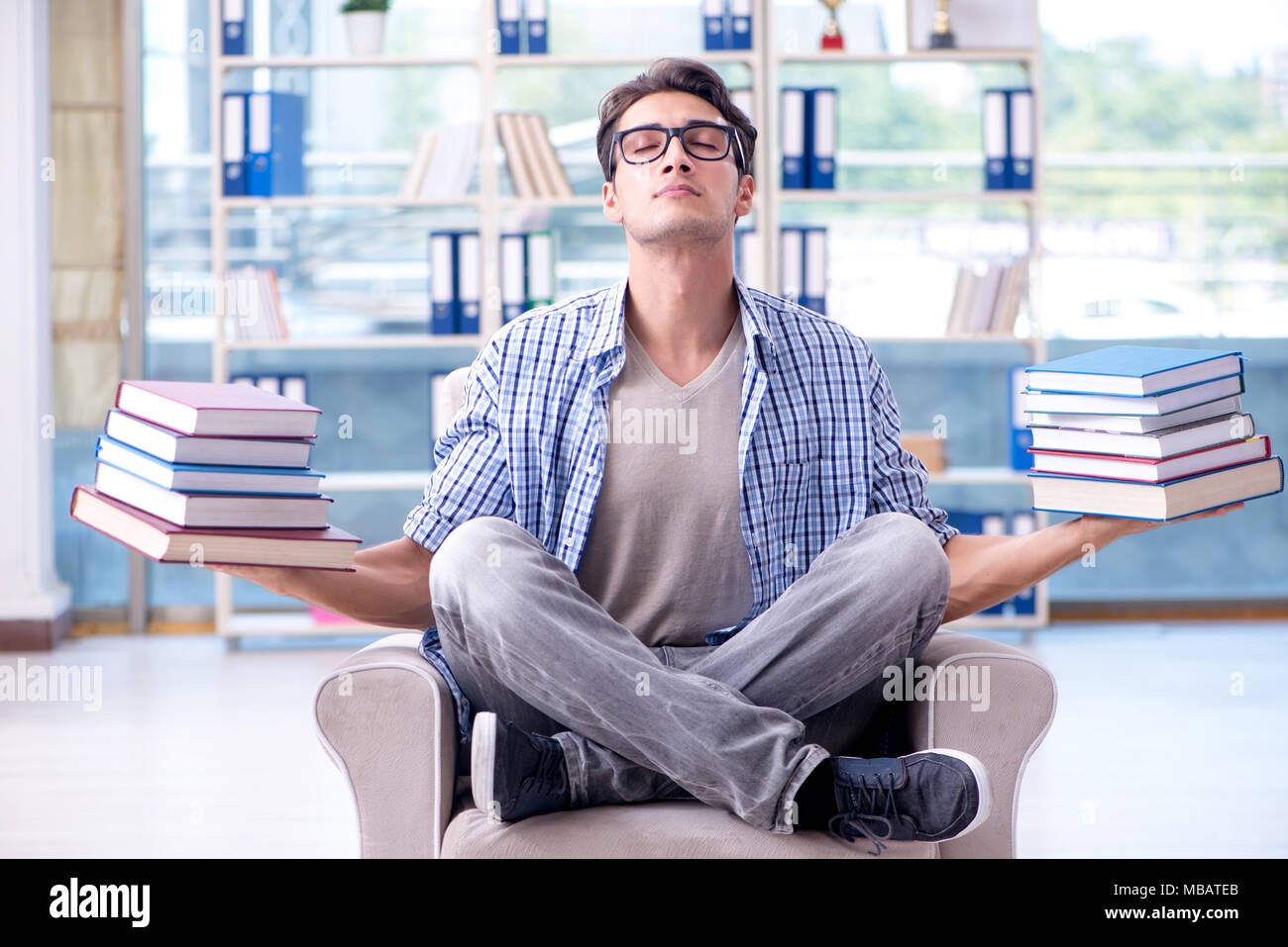 Student reading books and preparing for exams in library Stock Photo ...
