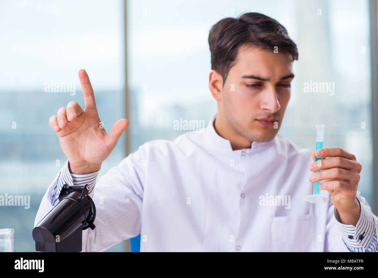 Young chemist pressing virtual buttons in lab Stock Photo - Alamy