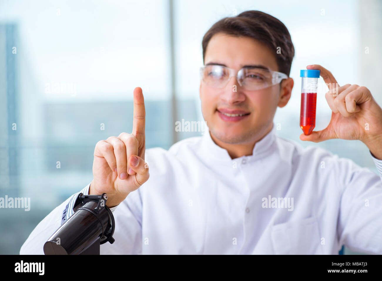 Man doctor checking blood samples in lab Stock Photo - Alamy