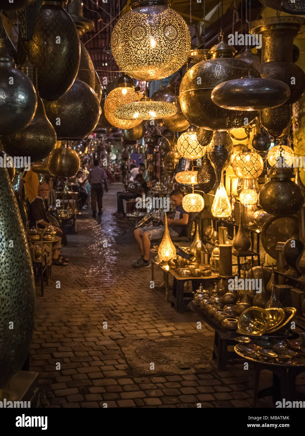 Glowing lamps fill a souk passageway in Marrakech, Morocco. The photo ...