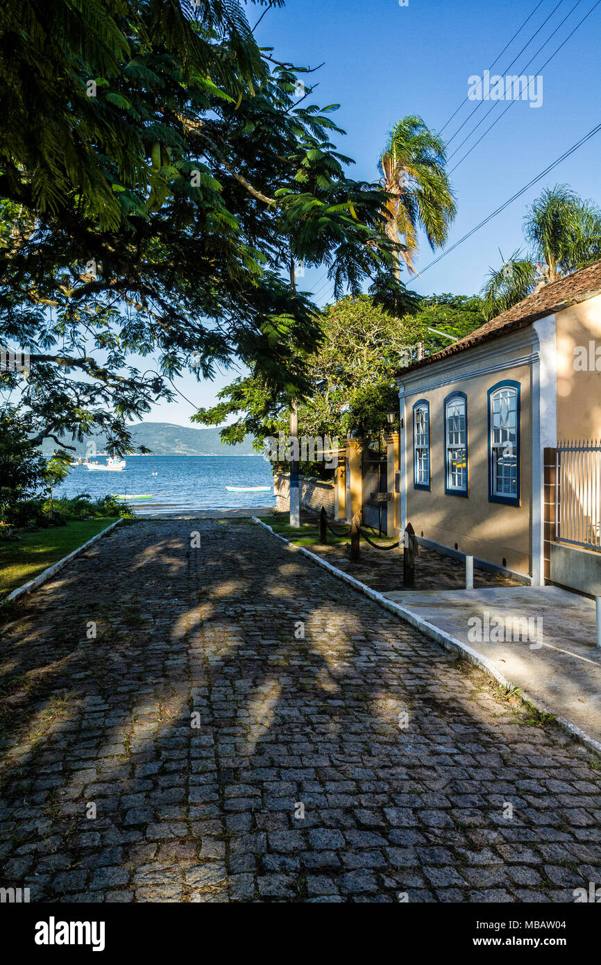 Cobblestone street with colonial architecture houses at Enseada do ...