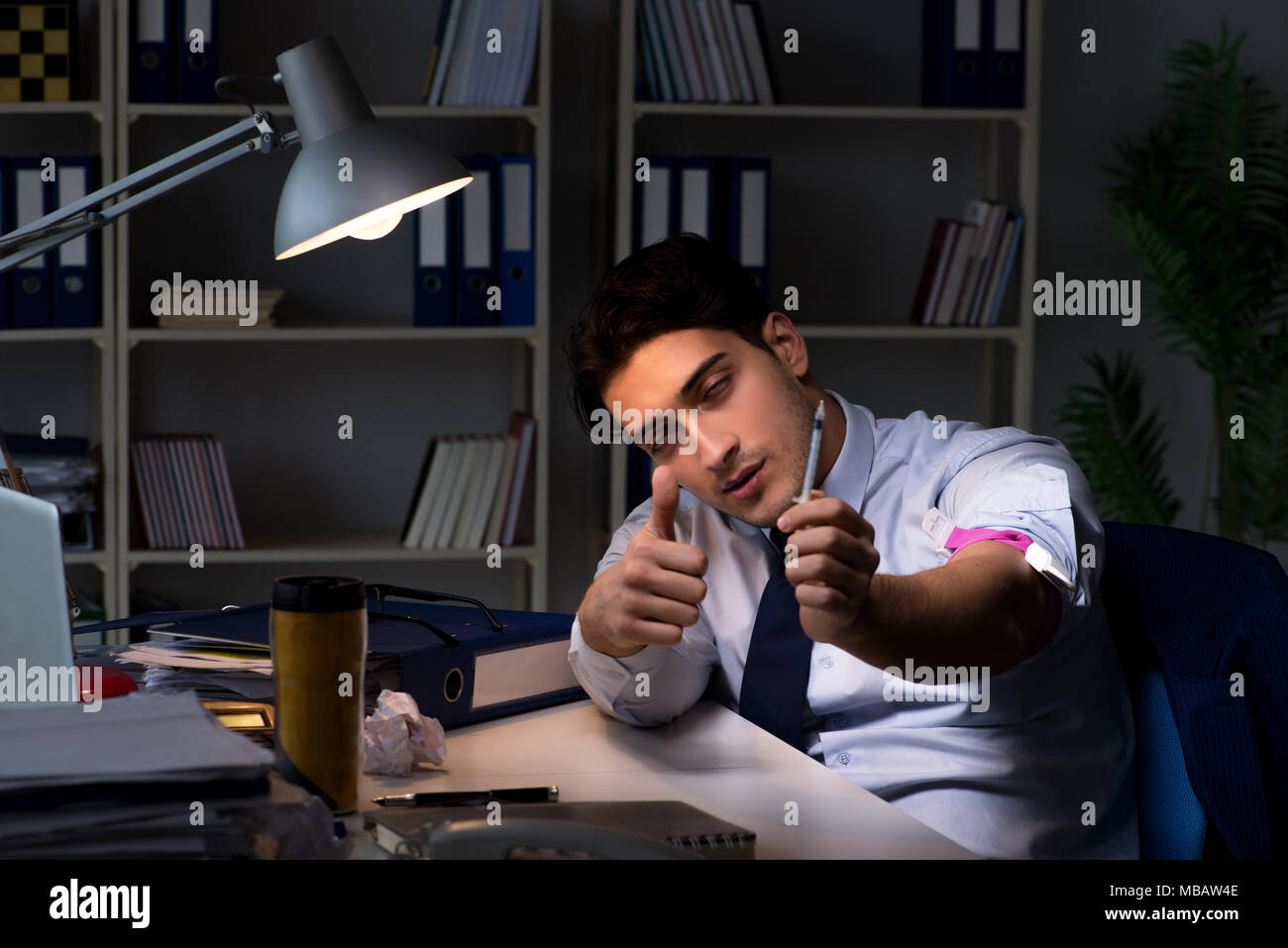 Employee relieving stress from overtime with drugs narcotics Stock ...