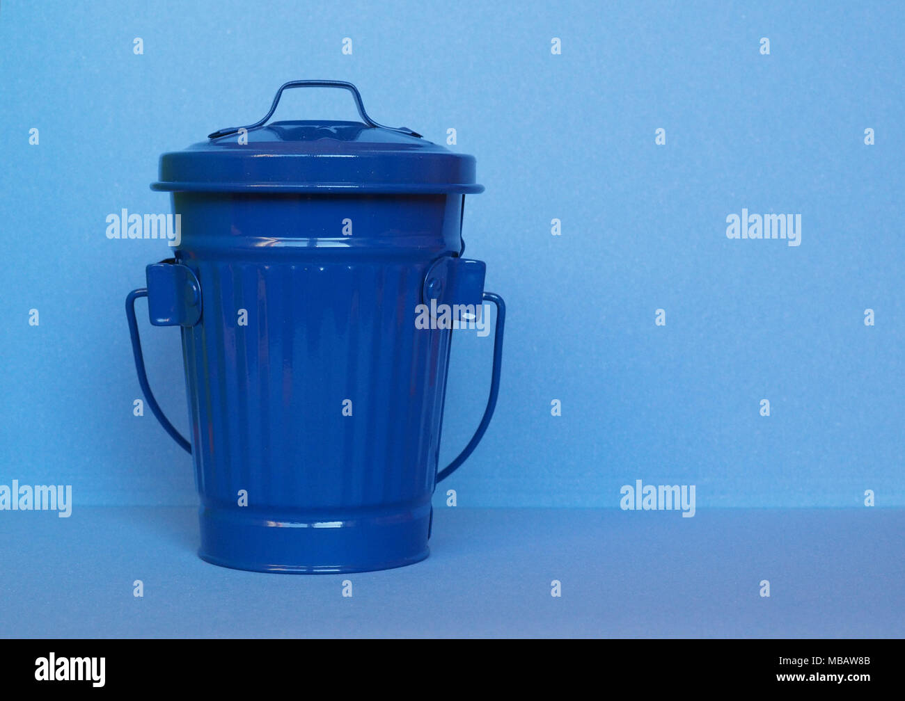 blue litter bin aka garbage or trash bin or waste bin with copy space ...