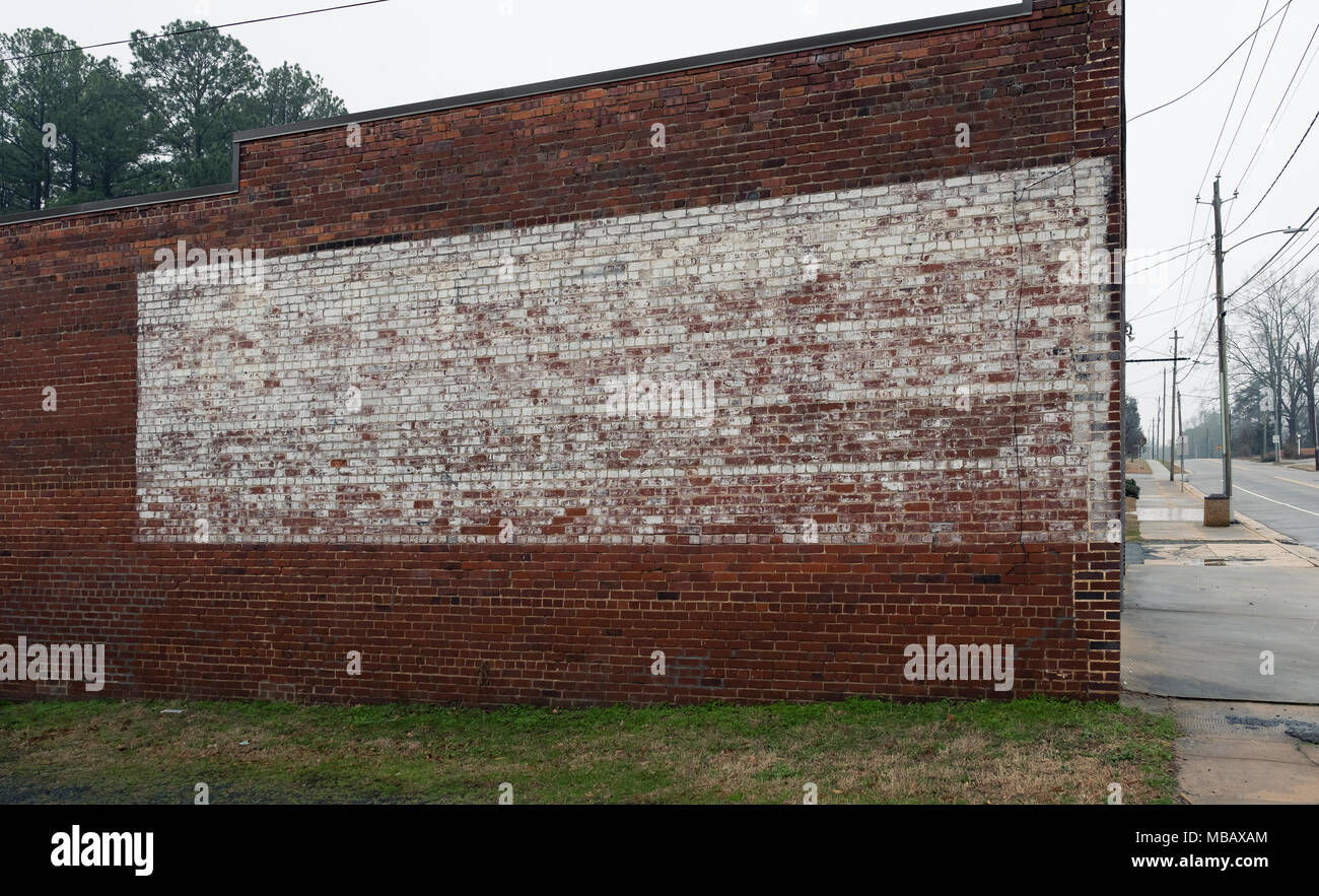 faded painted sign on rustic old brick wall texture store or building ...