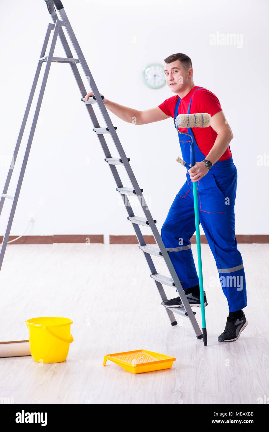 Male painter preparing for painting job at construction site Stock ...