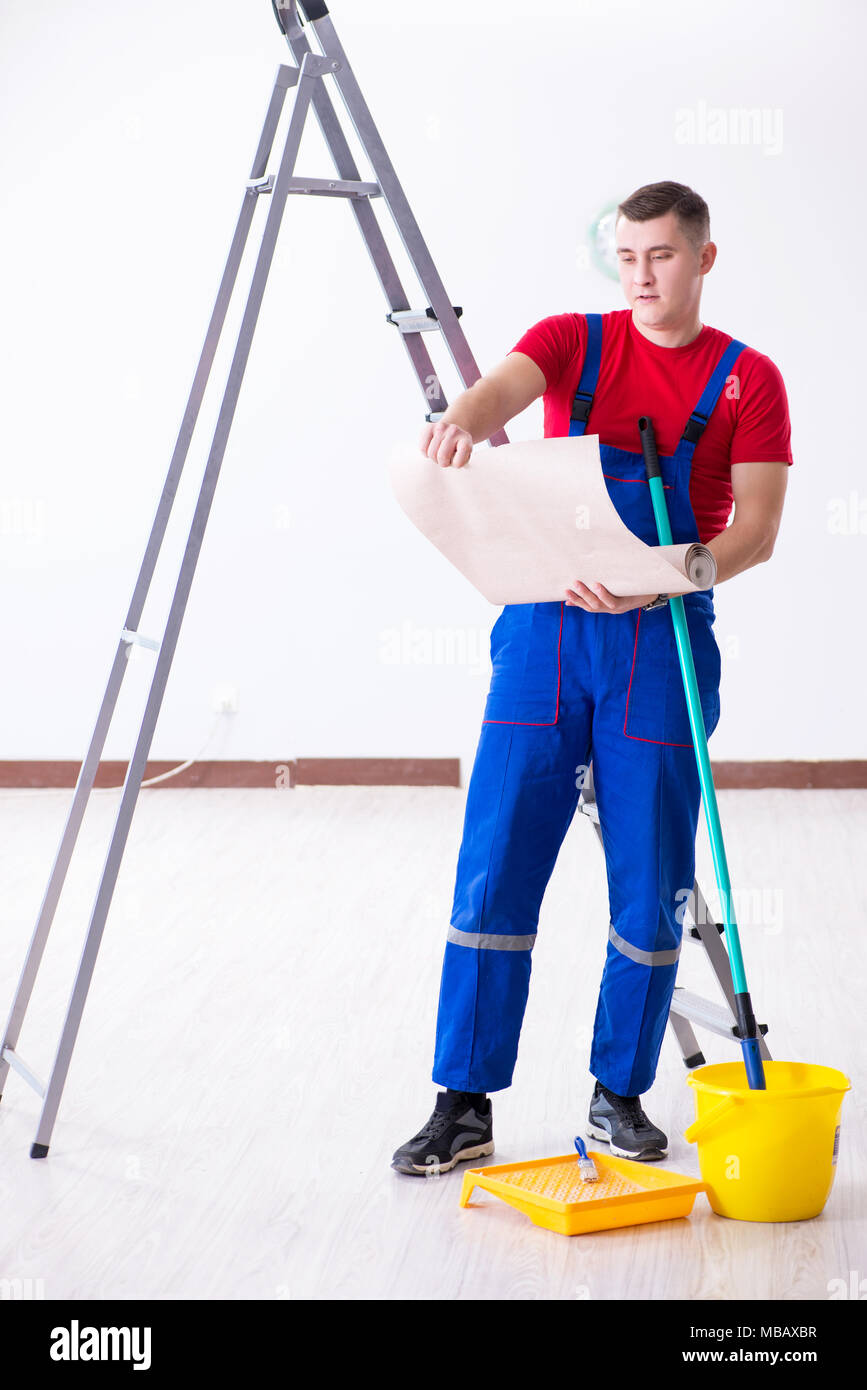 Contractor worker preparing for wallpaper decoration Stock Photo - Alamy
