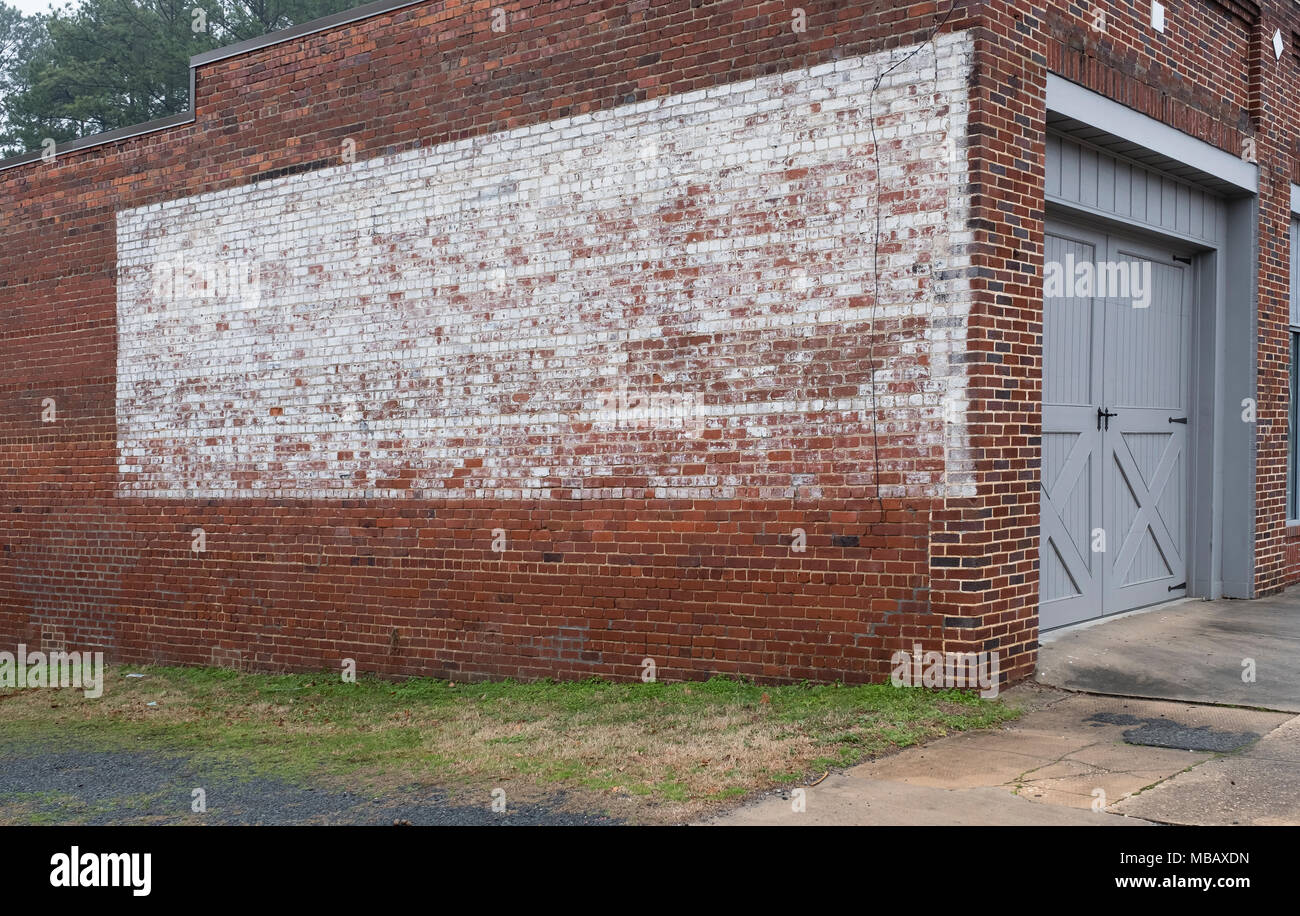 faded painted sign on rustic old brick wall texture store or building ...