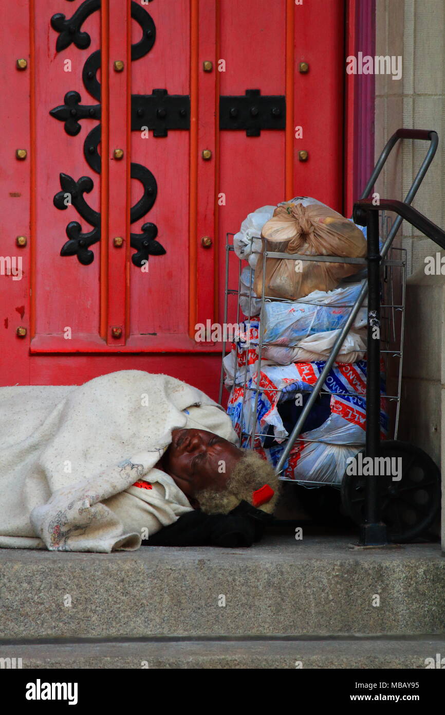 Homeless person sleeping in front of church entrance Stock Photo - Alamy