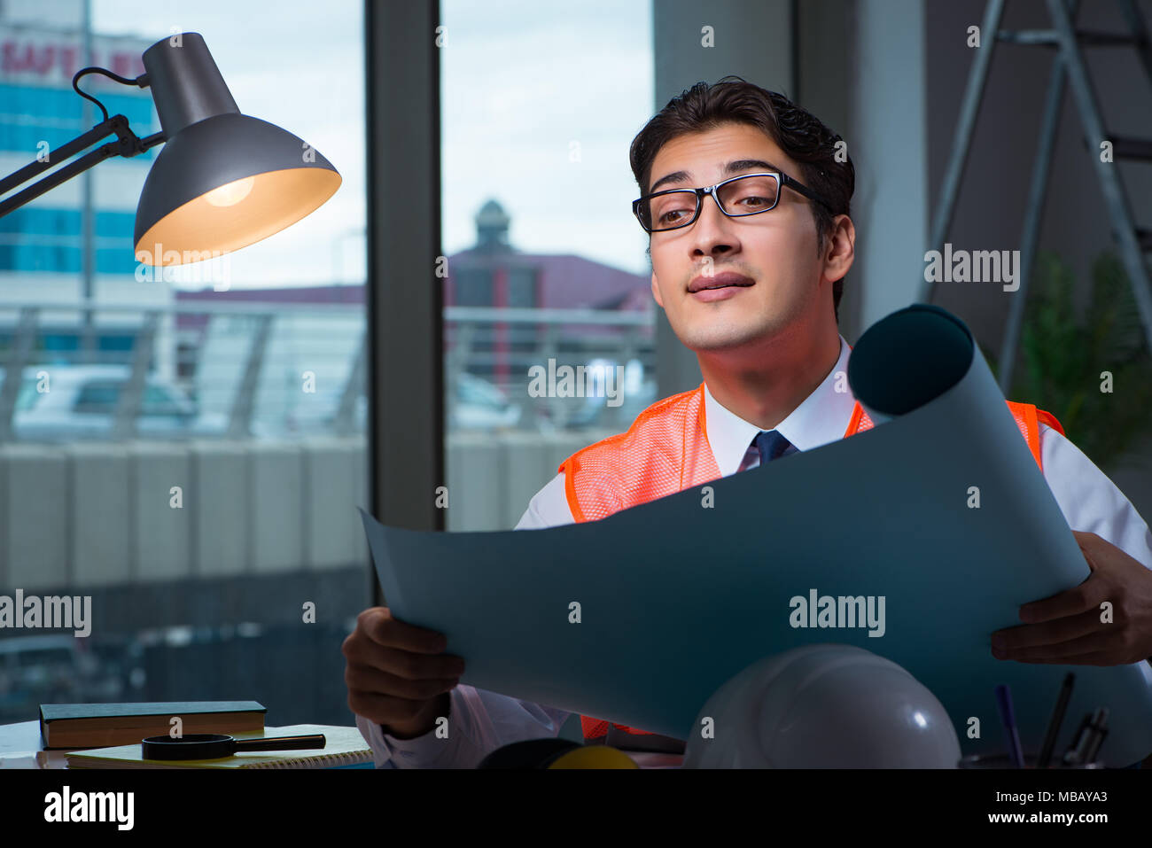 Construction architect working on drawings late at night Stock Photo ...