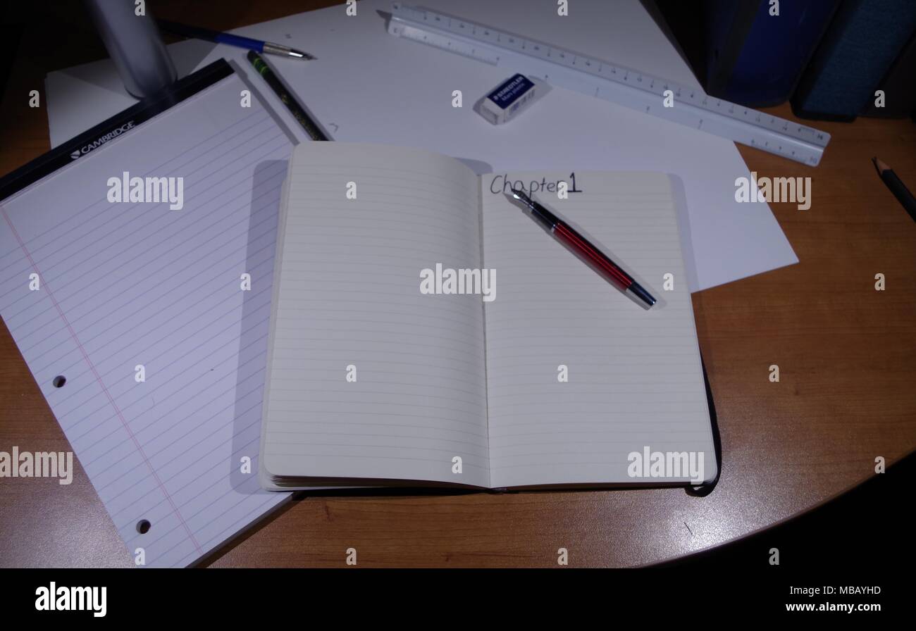 Writing books laying on a wooden desk Stock Photo - Alamy
