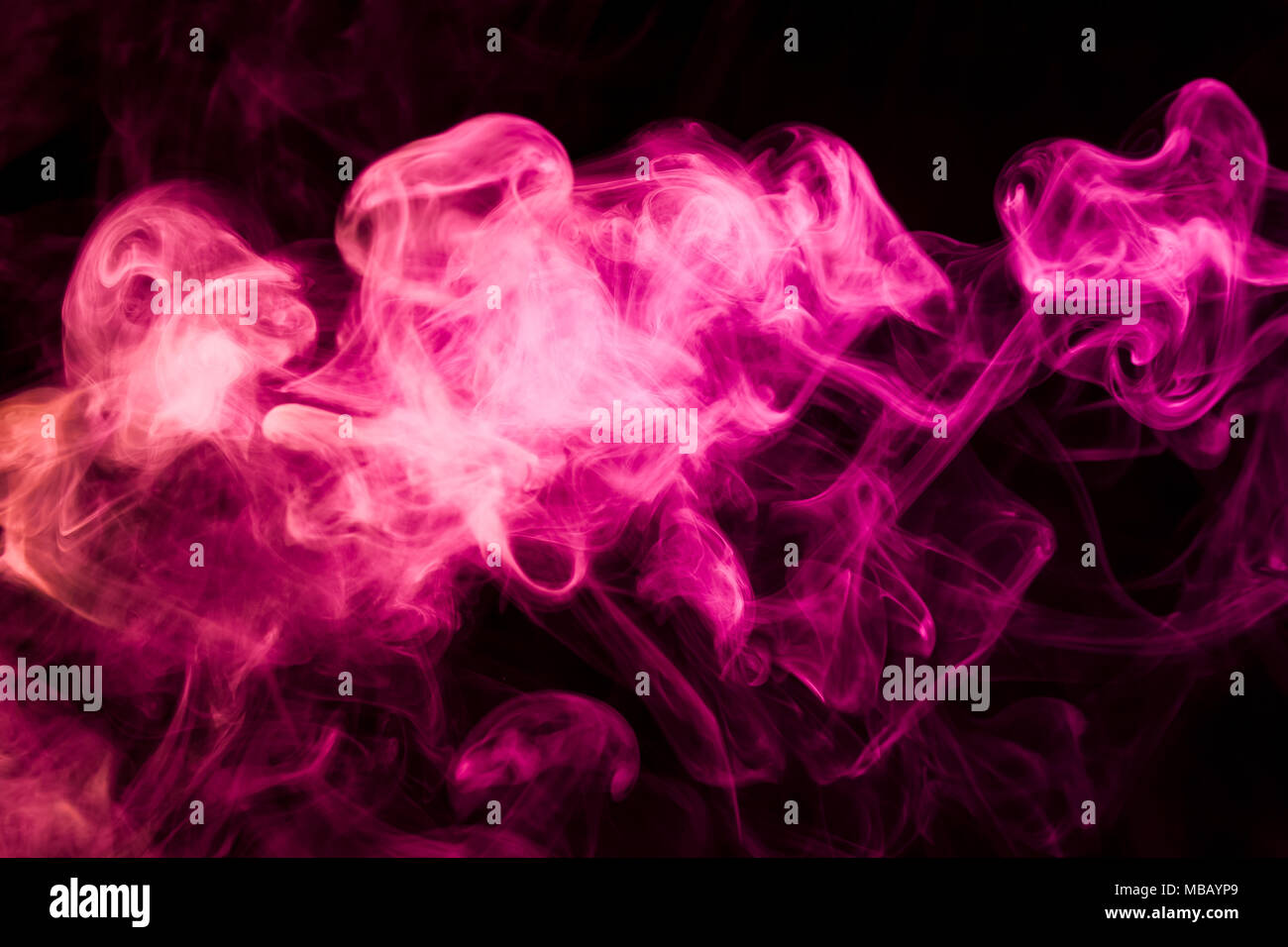 Pink and red cloud of smoke of black isolated background. Background ...