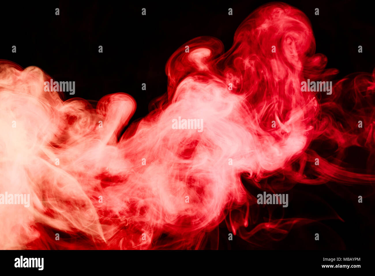Pink and red cloud of smoke of black isolated background. Background ...