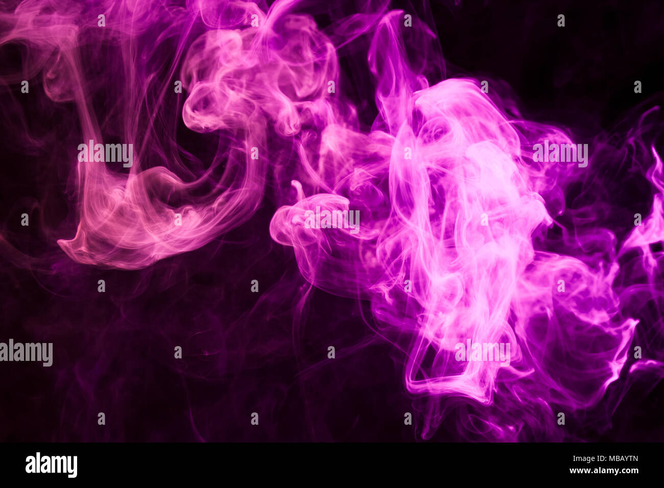 Dense multicolored smoke of pink and purple colors on a black isolated ...