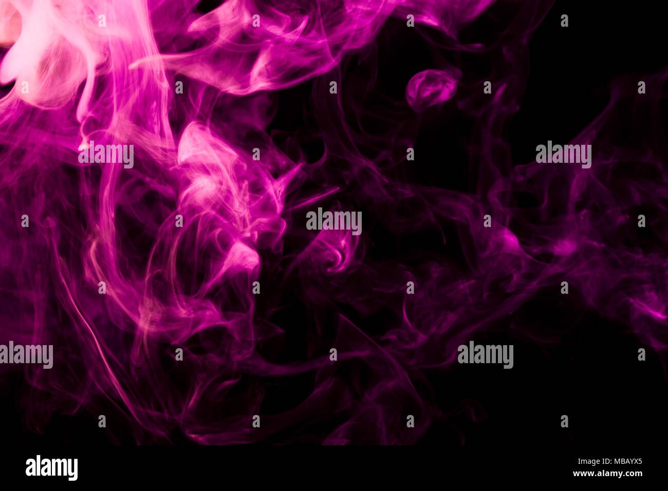 Thick pink and red colorful smoke on a black isolated background ...