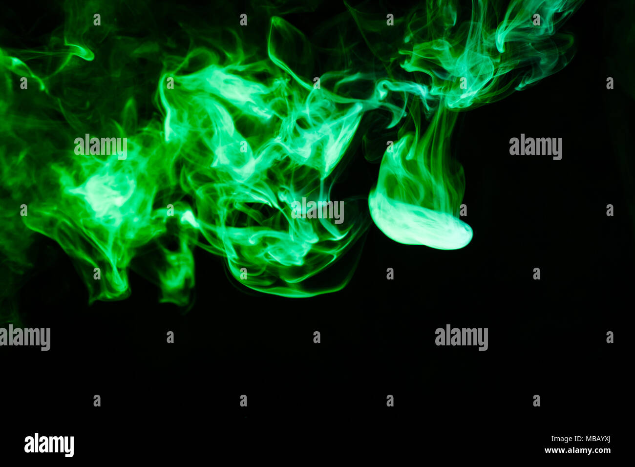 Thick green colorful smoke on a black isolated background. Background ...