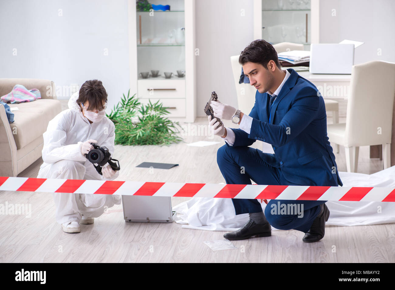 Forensics investigator at the scene of office crime Stock Photo - Alamy
