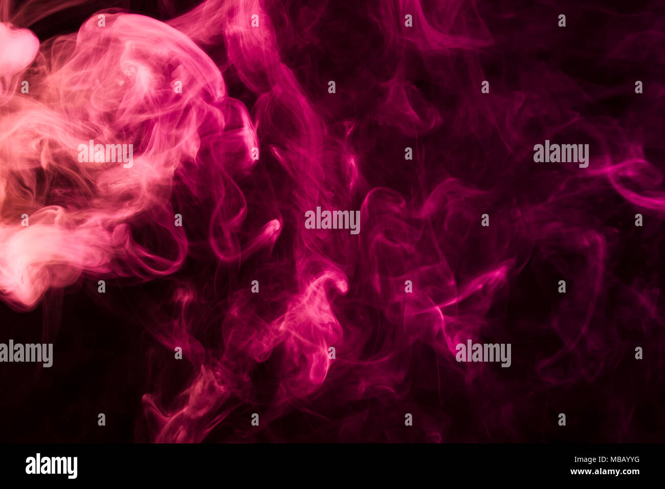 Pink and red smoke on black background Stock Photo - Alamy