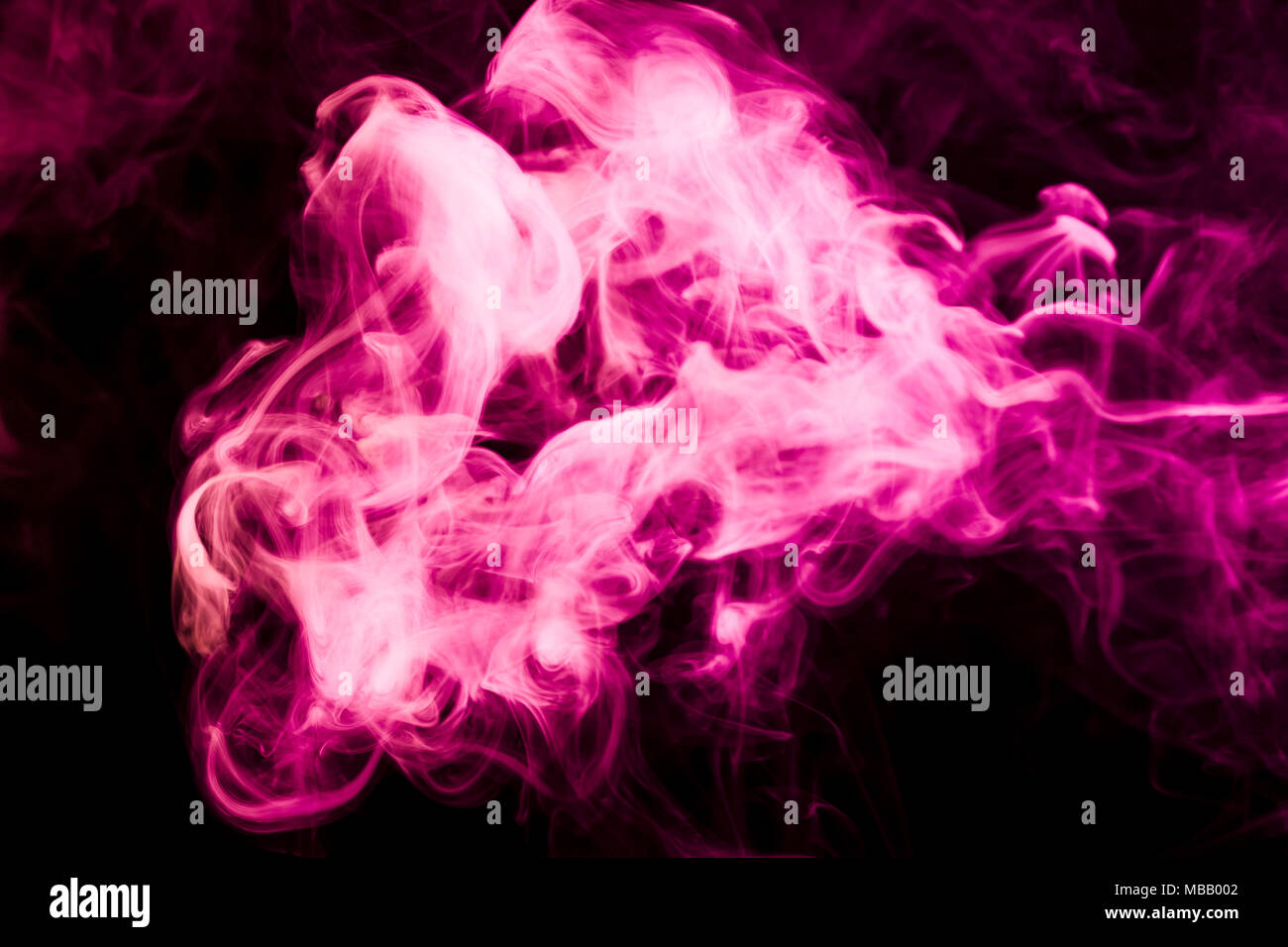Pink and red smoke on black background Stock Photo - Alamy