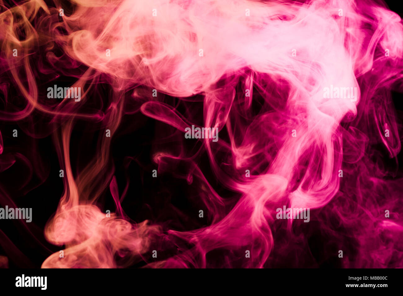 Pink and red smoke on black background Stock Photo - Alamy