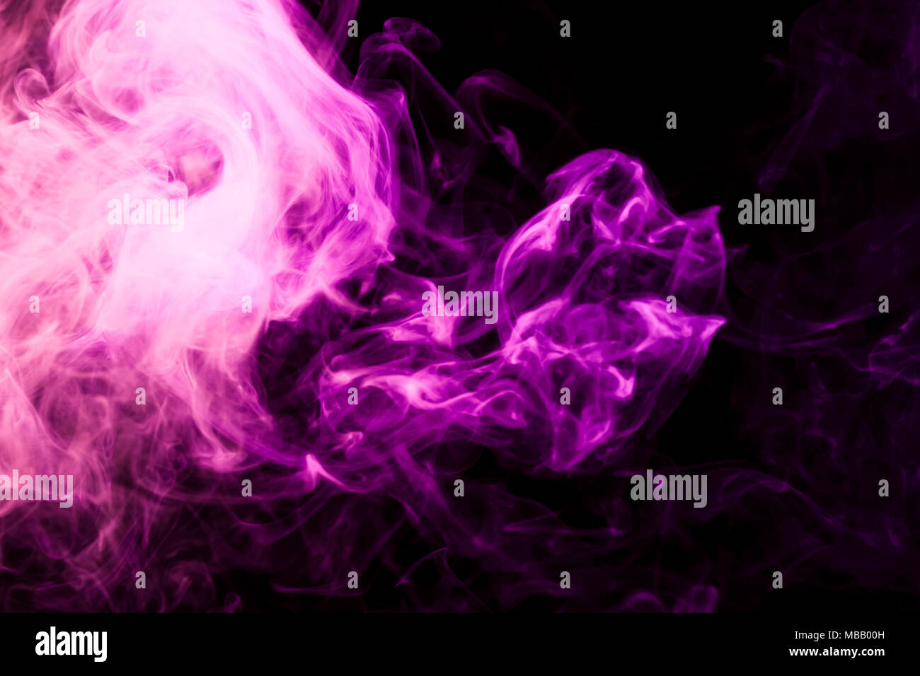 Pink and red smoke on black background Stock Photo - Alamy