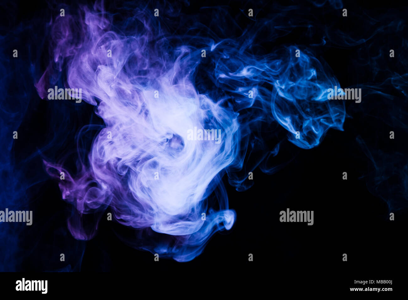 Colorful blue smoke on a black isolated background. Background from the ...