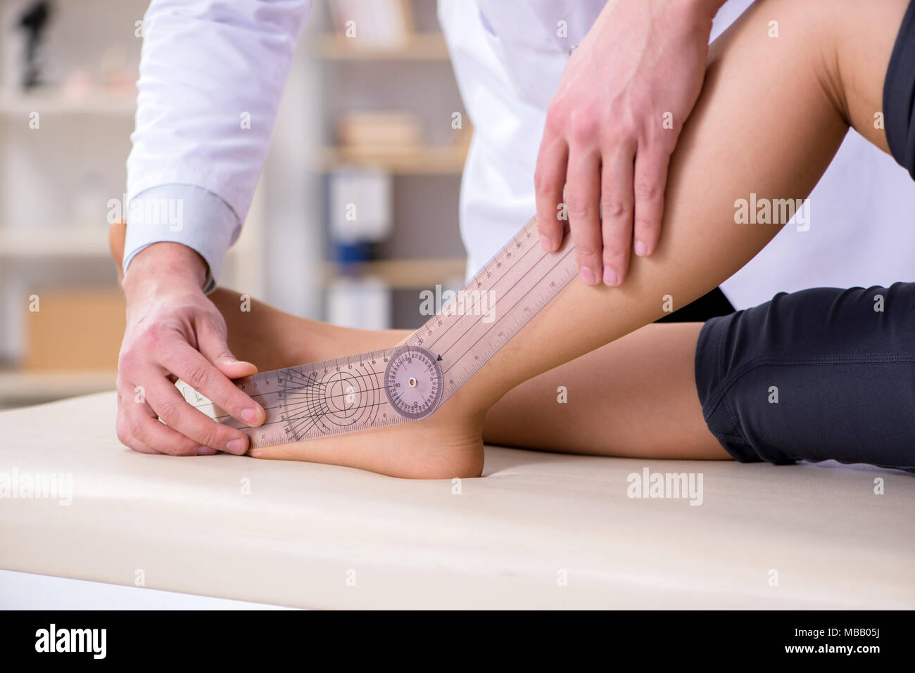 Doctor checking patients joint flexibility Stock Photo - Alamy