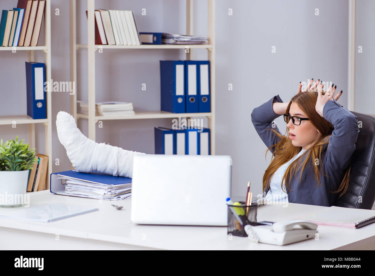 Busiesswoman employee with broken leg in office Stock Photo - Alamy