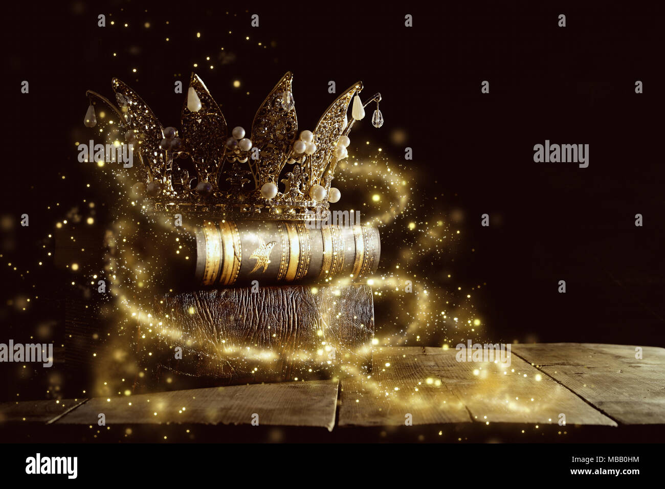 low key image of beautiful queen/king crown on old books. fantasy ...