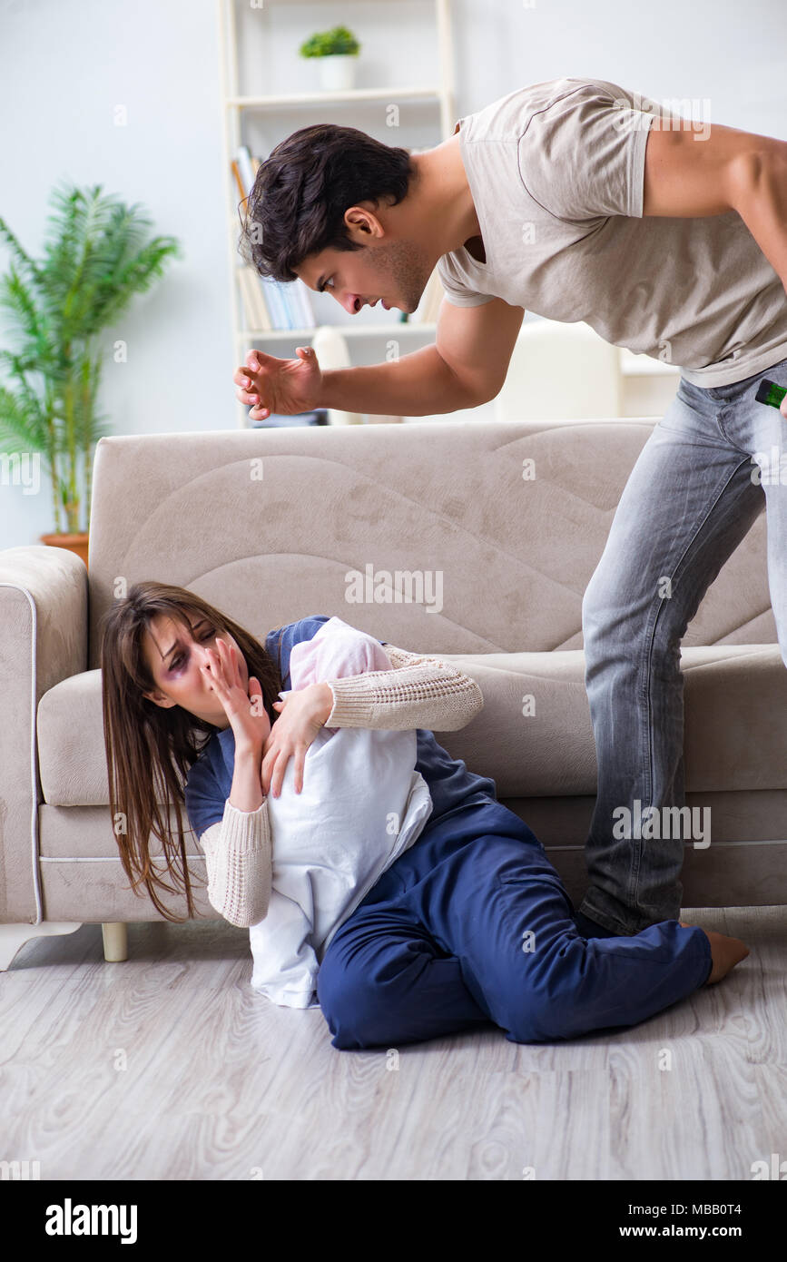 Desparate wife with aggressive husband in domestic violence concept ...