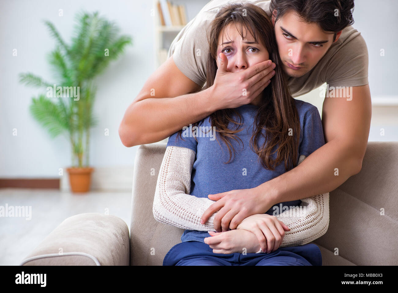 Desparate wife with aggressive husband in domestic violence concept ...