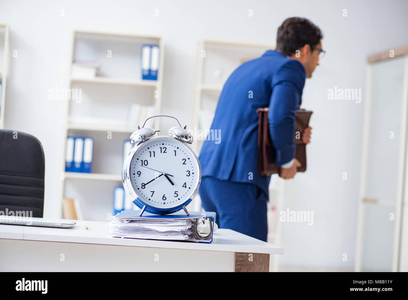 Businessman in bad time management concept Stock Photo - Alamy