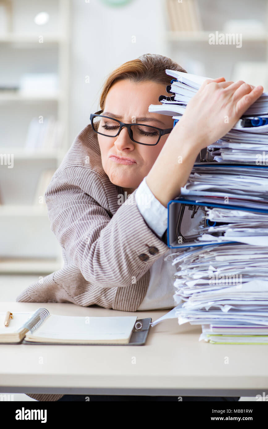Businesswoman very busy with ongoing paperwork Stock Photo - Alamy