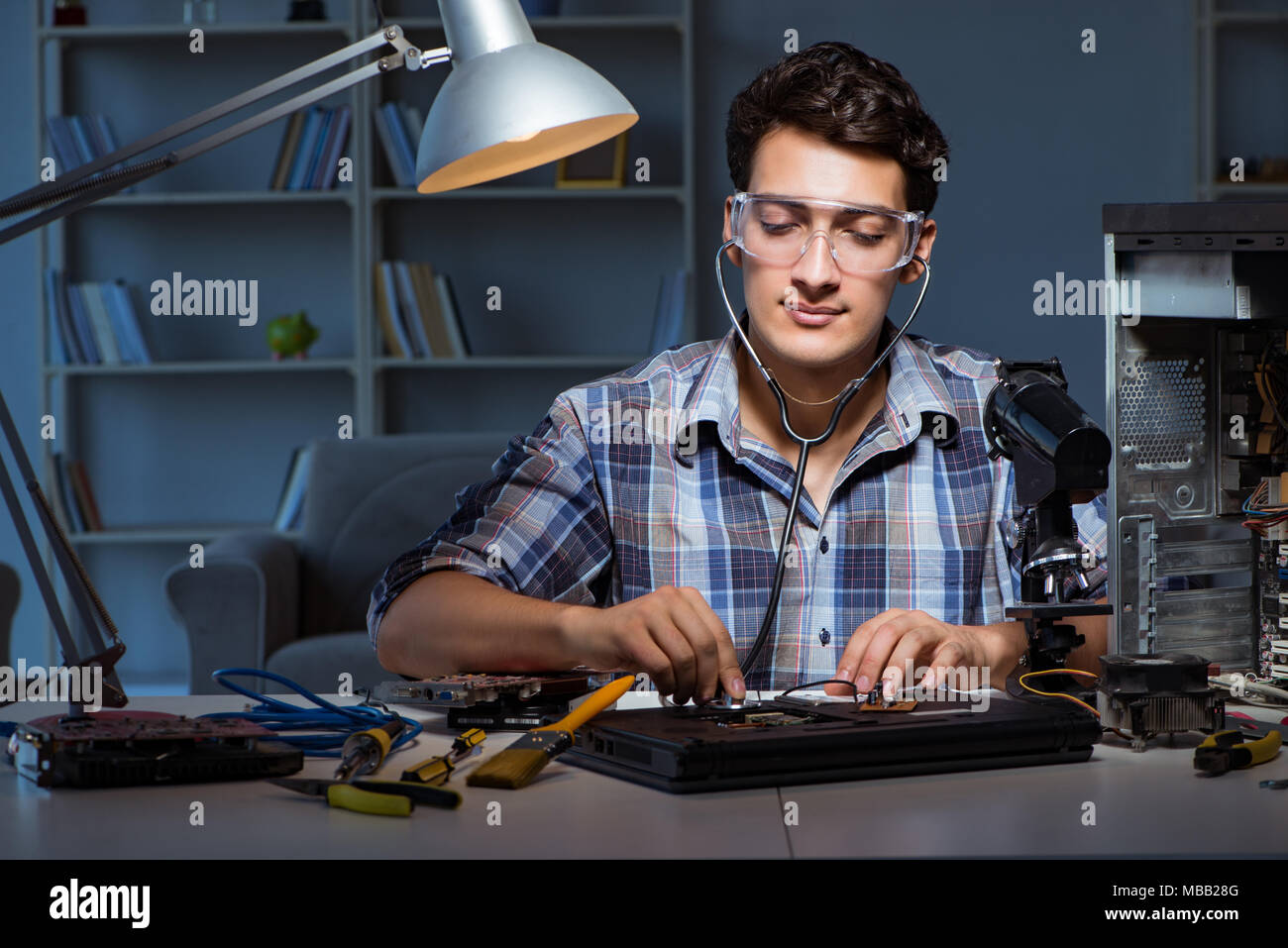Computer repair concept with man inspecting with stethoscope Stock ...