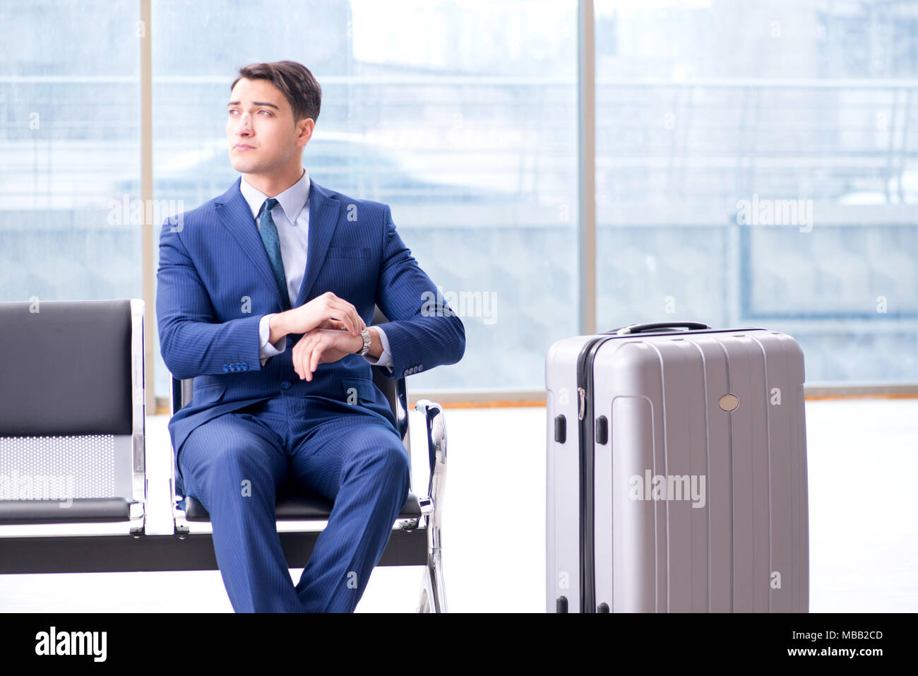 Businessman waiting at the airport for his plane in business class Stock Photo - Alamy